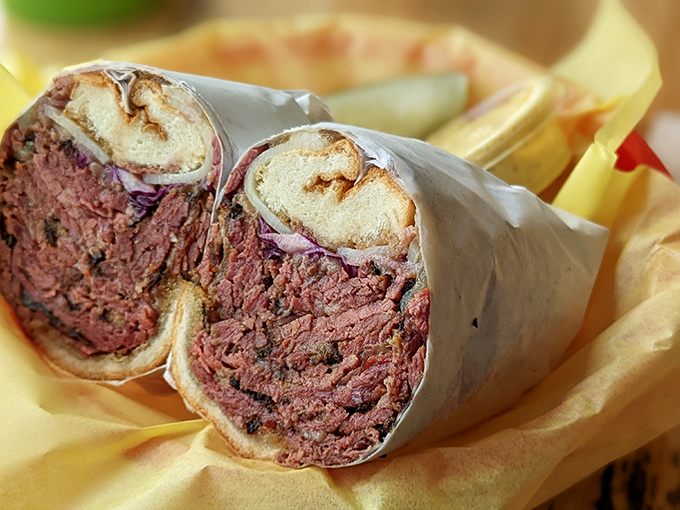 Not just pastrami, but a ruby-red testament to patience. Two weeks of brining, smoking, and steaming creates this sandwich masterpiece.