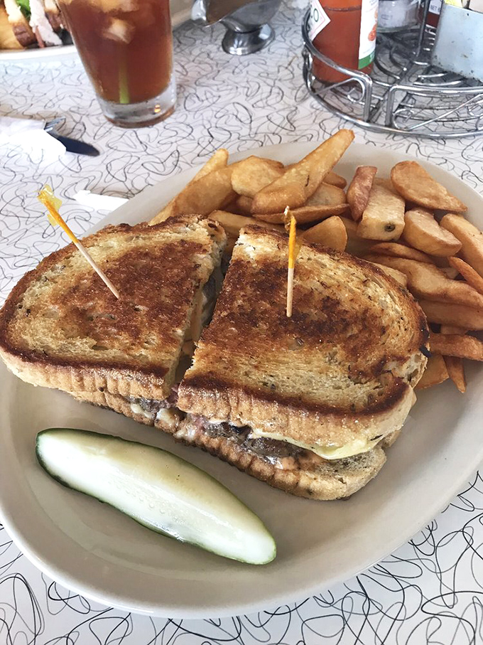 A perfectly executed patty melt – that magical union of beef, cheese, and grilled bread that somehow tastes better in a diner than anywhere else on earth.