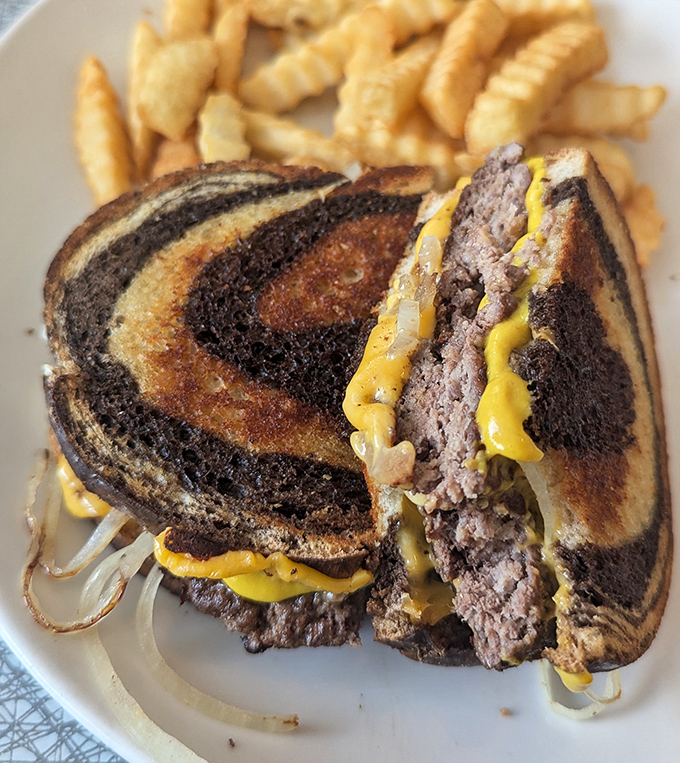 The patty melt&mdash;that perfect marriage of beef, cheese, and grilled marble rye&mdash;served with crispy fries that somehow manage to stay crispy until the last bite.