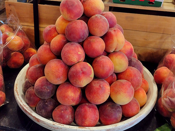 These peaches are stacked higher than my weekend to-do list, each one promising the kind of juicy sweetness that makes summer worth the wait.