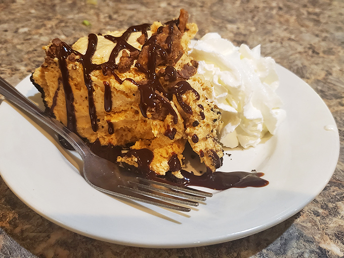 Peanut butter pie with chocolate drizzle and whipped cream&mdash;a dessert so good it should require signing a happiness waiver.