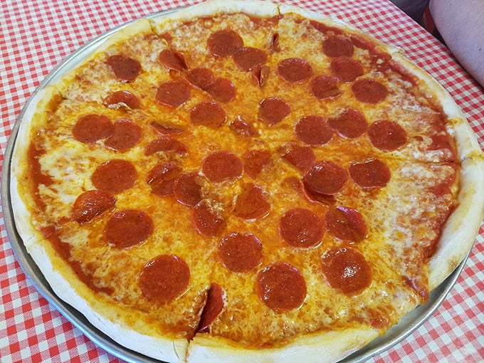 Pepperoni arranged with mathematical precision, each disc curling at the edges to form those coveted crispy cups of savory goodness. A timeless classic executed flawlessly.