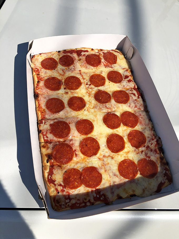 Old Forge pizza isn't round but rectangular, with pepperoni arranged in perfect formation like delicious little soldiers guarding their cheesy kingdom.