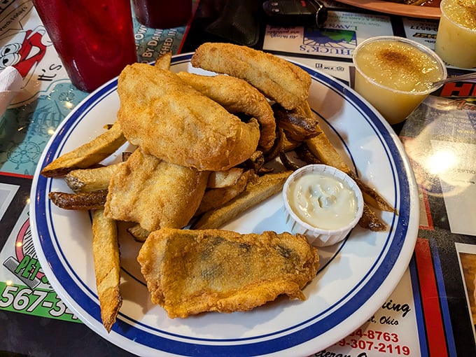 The perch platter arrives like a mountain of golden treasures, each piece more delicious than the last, with fries standing guard.