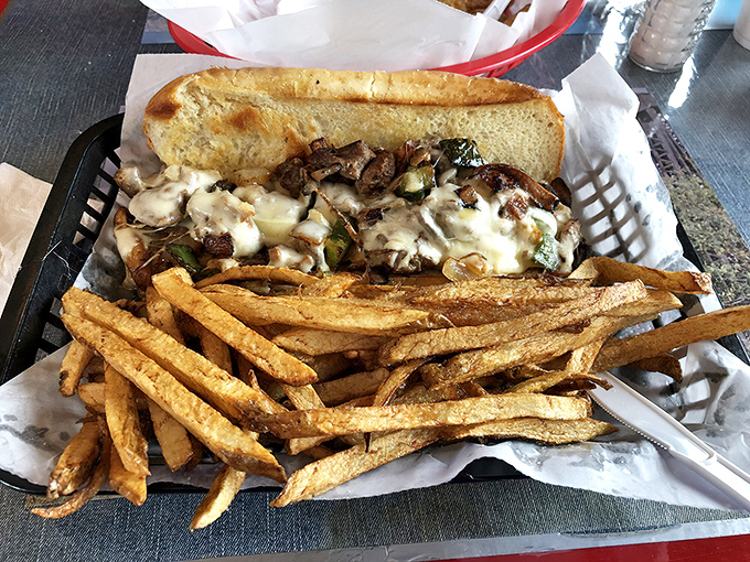 This isn't just a Philly cheesesteak – it's a masterpiece of melted cheese, caramelized onions, and tender beef that demands both hands.