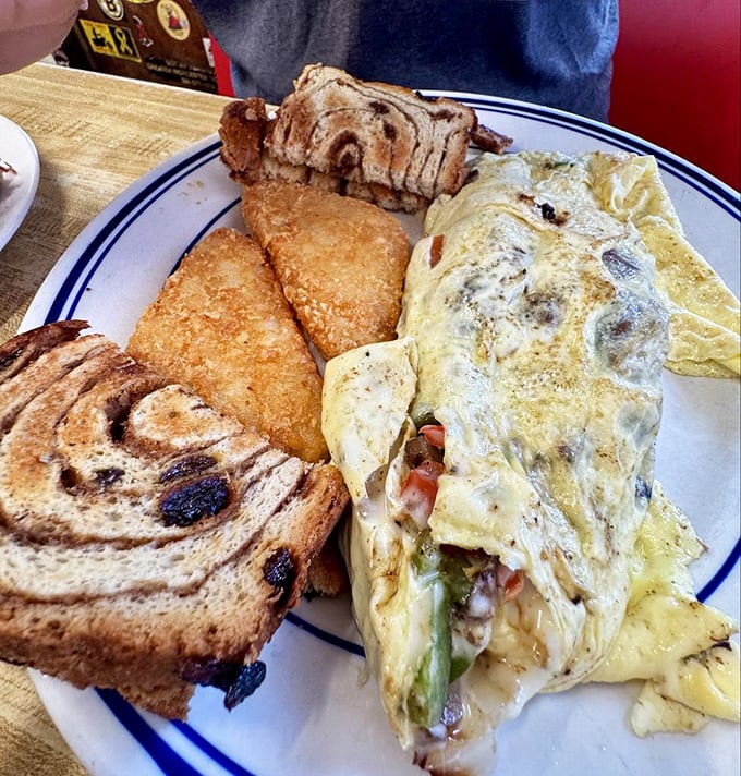 The perfect omelet doesn't exi&mdash; Oh wait, here it is! Perfectly folded around fresh vegetables and melty cheese, with cinnamon raisin toast standing guard.