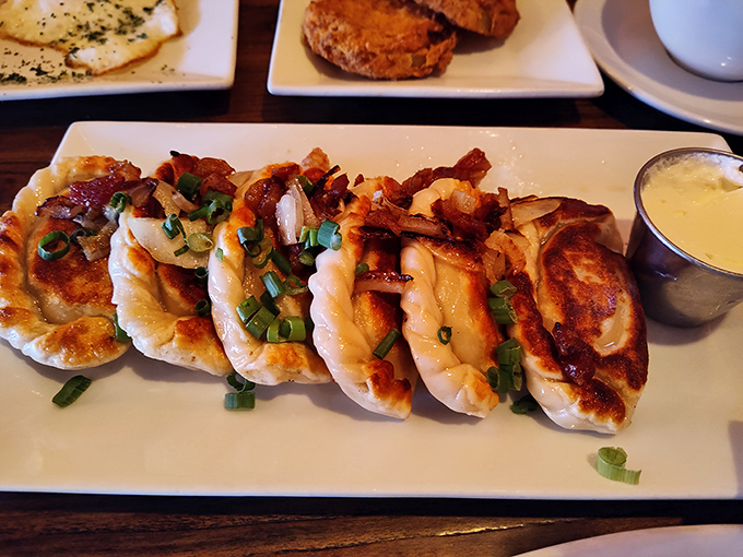 These golden-brown pierogies aren't just dumplings; they're little pockets of joy topped with bacon and green onions for good measure.