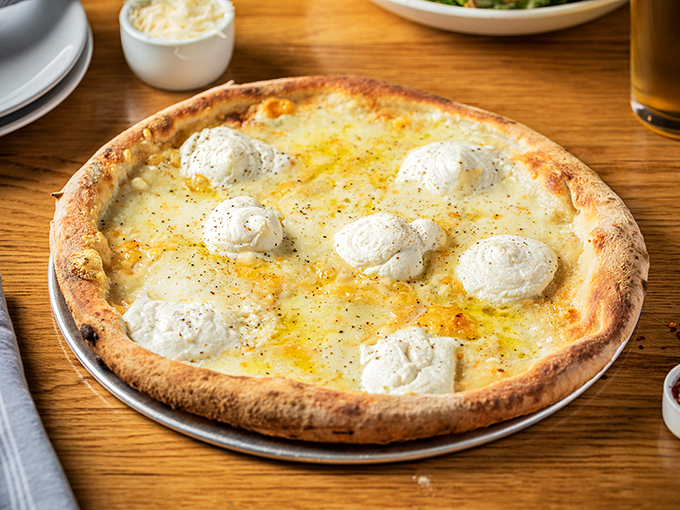 That white pizza whispers sweet nothings about ricotta clouds floating on a golden crust &ndash; resistance is futile.