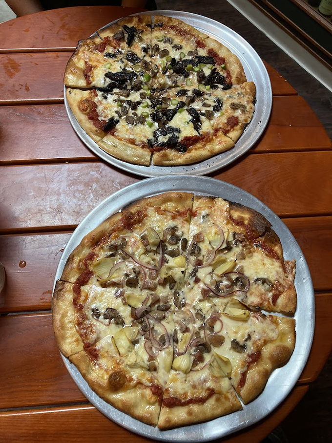 These aren't just pizzas&mdash;they're edible works of art with crusts that crackle and toppings that tell stories. The bottom one is whispering sweet nothings about caramelized onions.