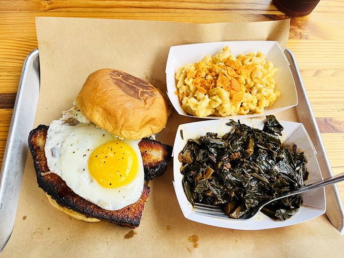 This pork belly sandwich with a sunny-side-up egg isn't just breakfast meeting lunch&mdash;it's a flavor summit with mac and cheese and greens as honored delegates. 