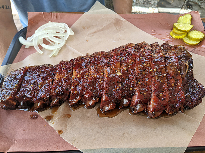 These ribs have the kind of glaze that makes you temporarily forget your table manners. The smoke ring is practically a halo.