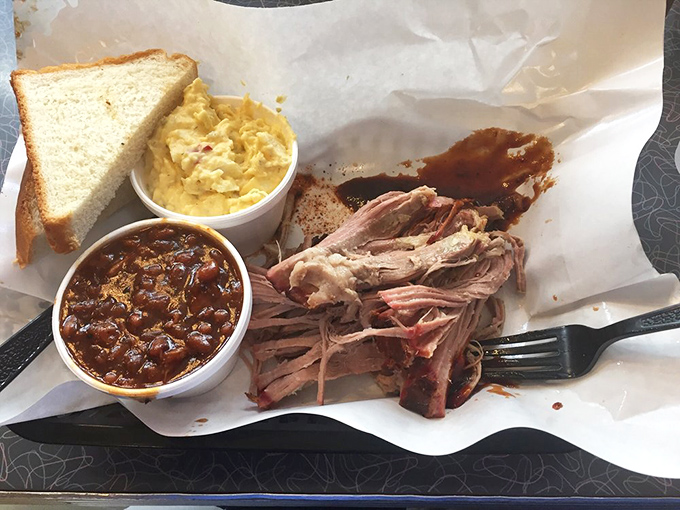 Pork that's had a proper introduction to smoke and time. These tender strands of pulled pork practically glisten with flavor, making that simple white bread the luckiest carbohydrate in Missouri.