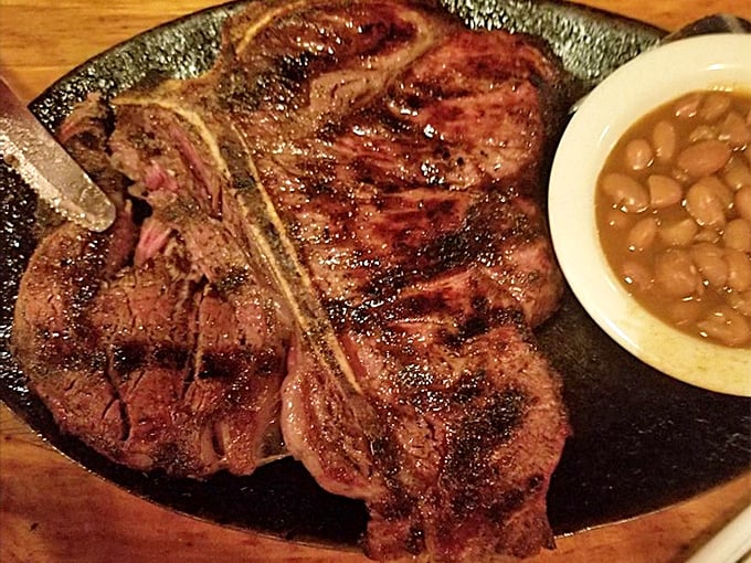 This porterhouse steak arrives with grill marks that look like modern art, but taste infinitely better than any gallery piece.