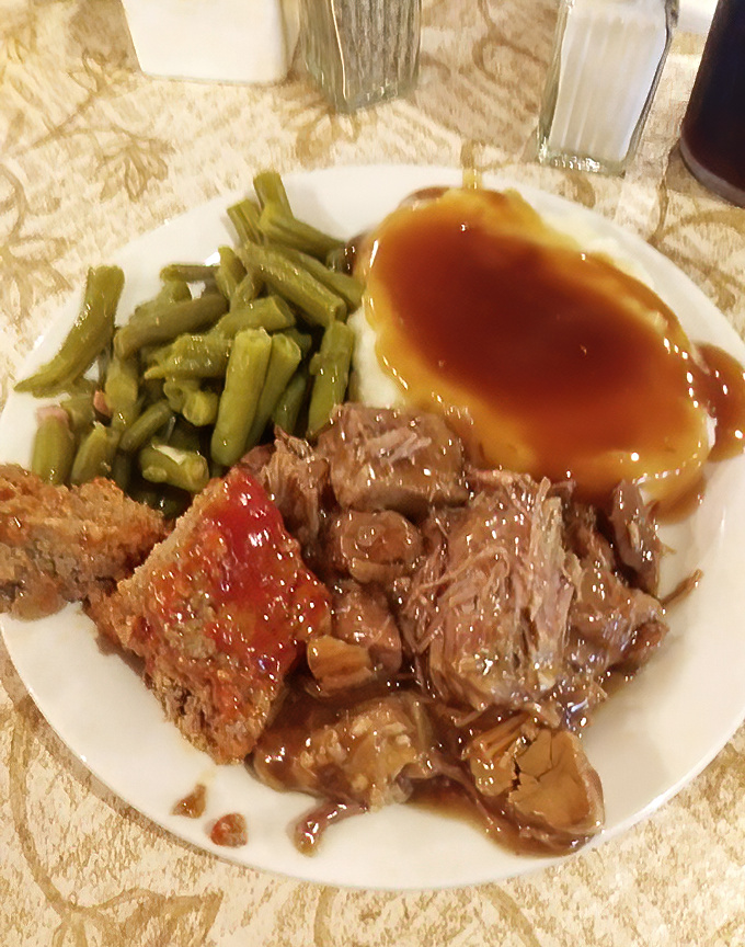 Tender pot roast swimming in rich gravy with perfectly cooked green beans proves comfort food never goes out of style.