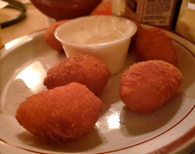 Golden-fried potato puffs that crunch like your childhood dreams, served with a side of nostalgia and enough calories to fuel a small tractor pull.