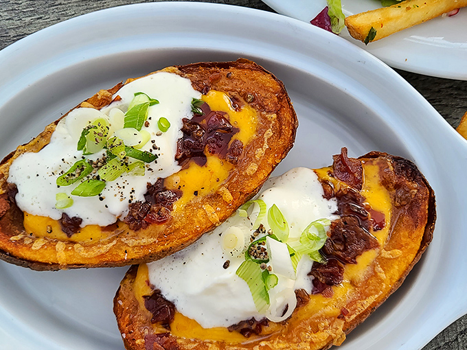 Loaded potato skins that make you question why anyone bothered inventing molecular gastronomy when perfection already existed.