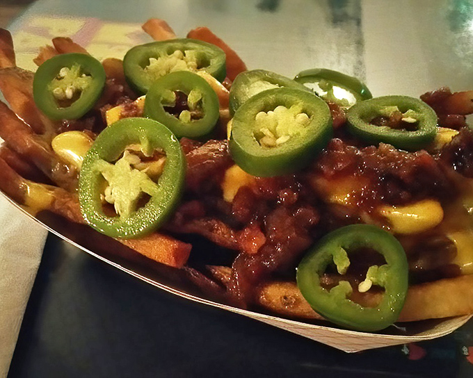 Jalapeños standing guard over what might be the most indulgent loaded fries in Lansing—like nachos and poutine had a beautiful, cheese-drenched baby.