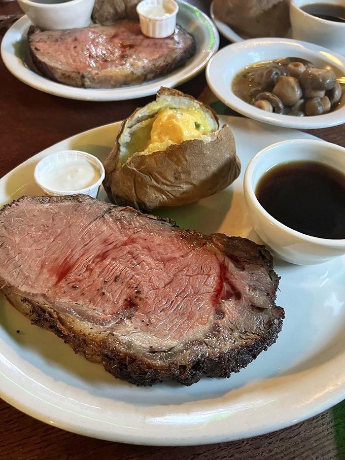 Prime rib so perfectly pink it could make a vegetarian weep, accompanied by a baked potato that's practically begging to be devoured.