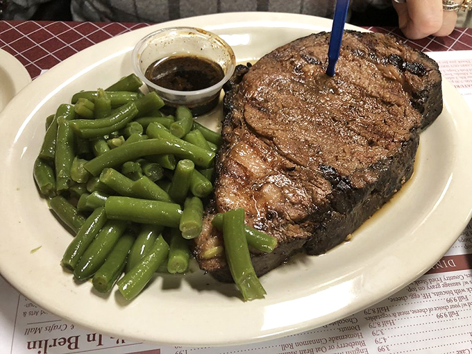 A steak that means business, paired with green beans that actually taste like vegetables should. No food stylists needed here.