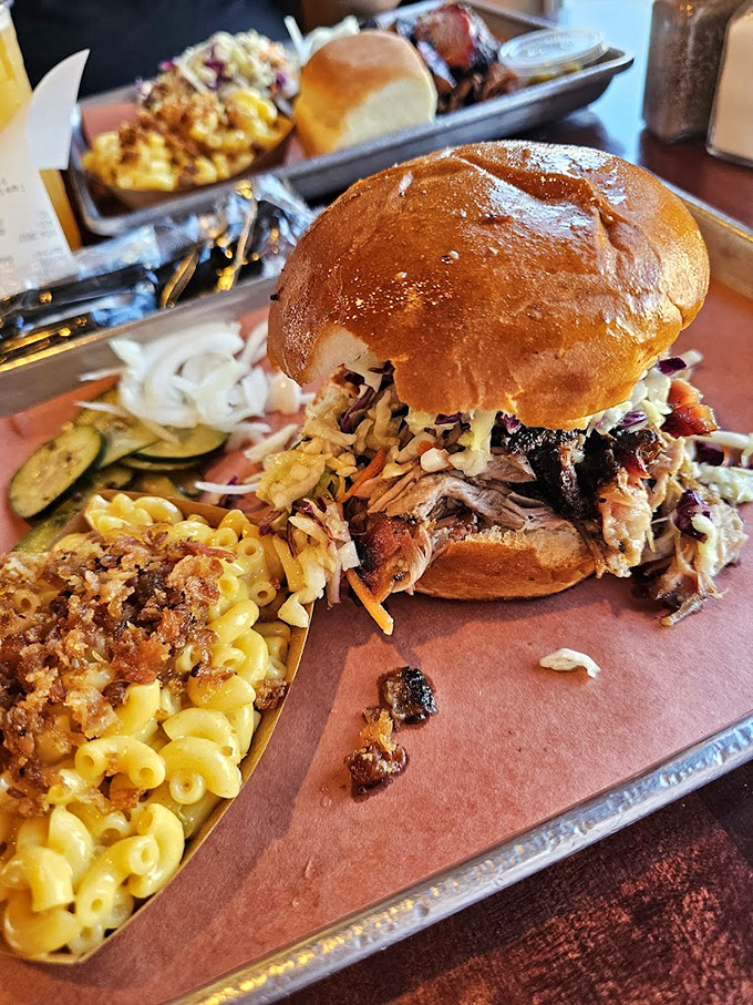 This pulled pork sandwich bursting from its bun is the kind of beautiful mess worth every napkin, paired with mac and cheese that's comfort in a cup.