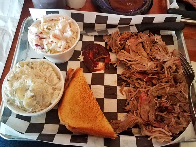 Pulled pork so tender it practically surrenders to your fork. The sides aren't afterthoughts&mdash;they're essential supporting characters.