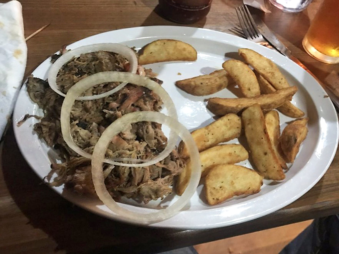 Pulled pork with rings of raw onion&mdash;nature's palate cleanser that ensures you taste every magnificent morsel of that slow-smoked goodness.