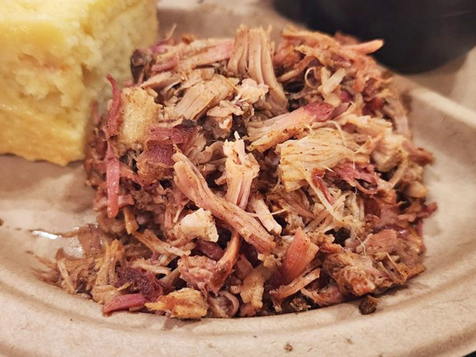 Pulled pork so tender it practically surrendered to the smoker, with that perfect pink smoke ring that makes barbecue enthusiasts weak in the knees.