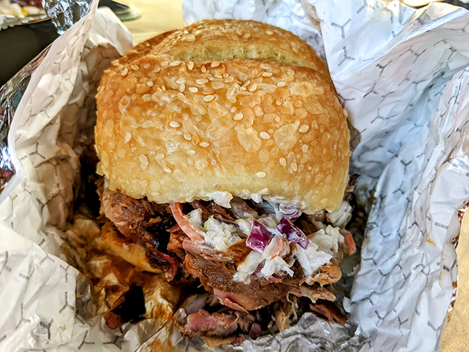 This pulled pork sandwich isn't just a meal, it's an event&mdash;piled high with meat and topped with slaw on a sesame bun.