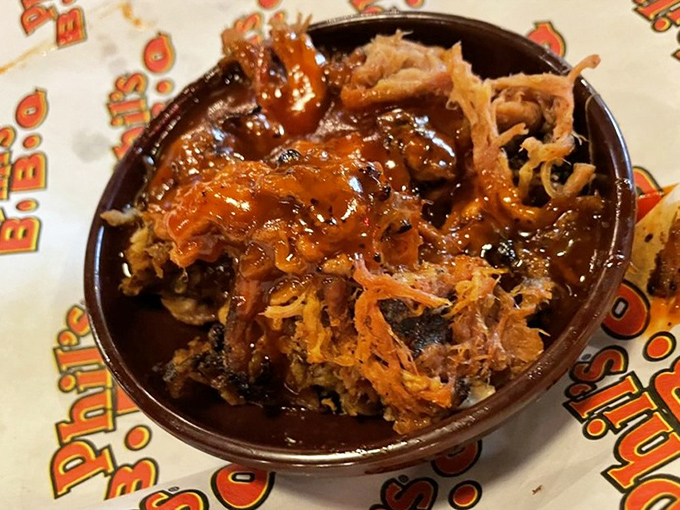 Pulled pork that doesn't need your permission to melt. This saucy, tender mountain of meat practically dissolves on contact, leaving behind only happy memories.