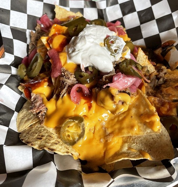 BBQ nachos that laugh in the face of utensils. A glorious mess of pulled meat, melted cheese, and jalape&ntilde;os that's worth every napkin.