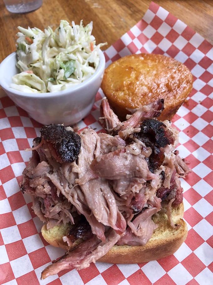 The pulled pork sandwich arrives like a meaty monument to patience &ndash; 14 hours of hickory smoking creates this masterpiece that's worth every napkin you'll need.