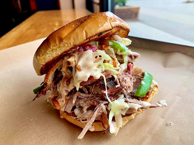 Architecture matters in a sandwich. This pulled pork masterpiece is engineered for maximum flavor delivery, with slaw providing that perfect textural counterpoint. 