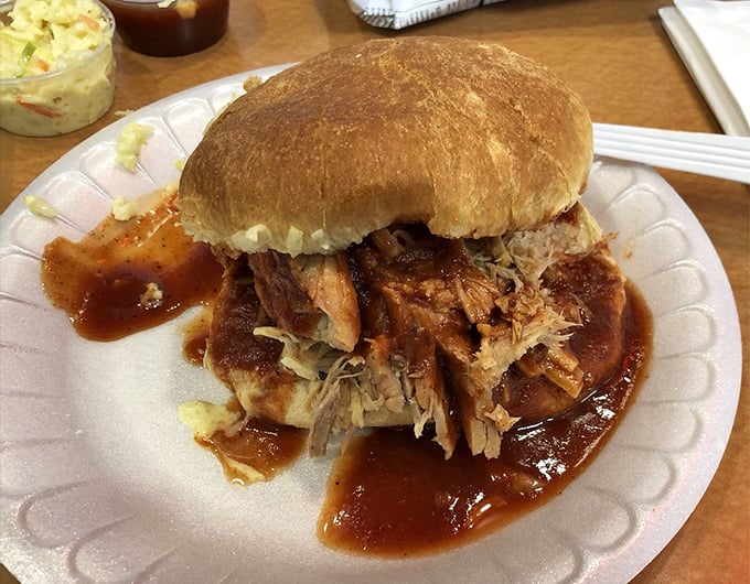 This isn't just a sandwich; it's a pulled pork masterpiece where sauce-soaked meat and pillowy bun create the ultimate comfort food tango.