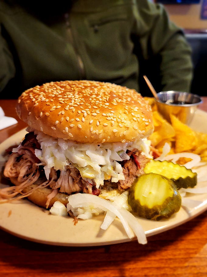 This pulled pork sandwich isn't just a meal &ndash; it's an architectural marvel of smoke-kissed meat, tangy slaw, and golden bun.