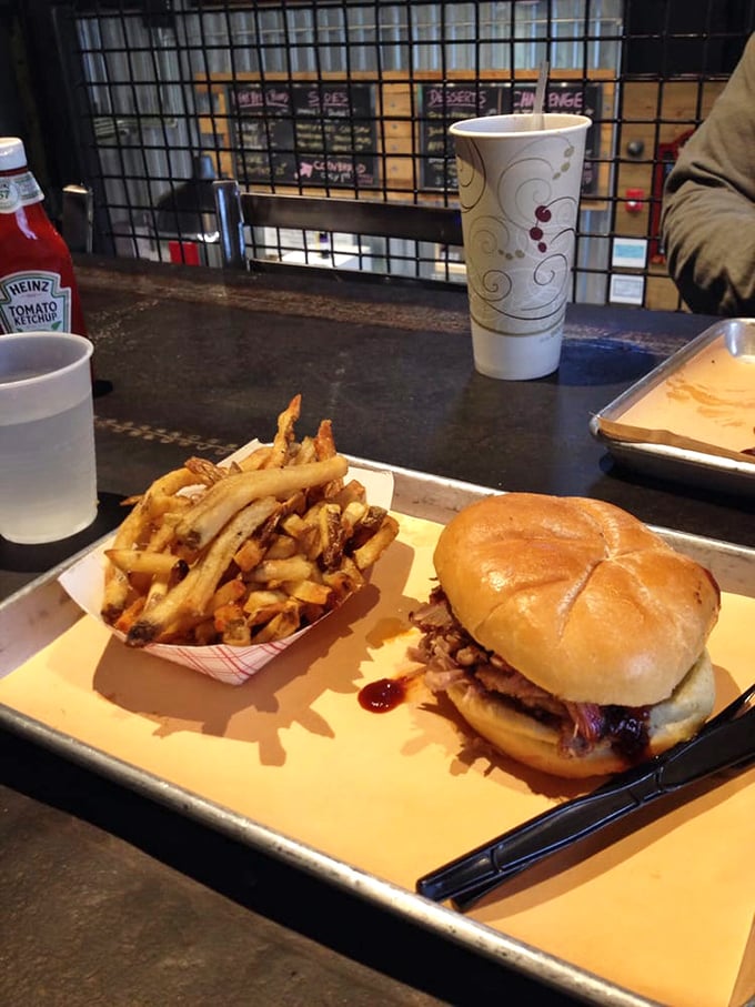 The sandwich that launched a thousand napkins—tender pulled pork nestled in a soft bun with fries that demand equal attention.