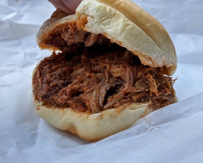 This isn't just a sandwich; it's a masterclass in pulled pork &ndash; tender, smoky meat piled high on a bun that somehow maintains its structural integrity.