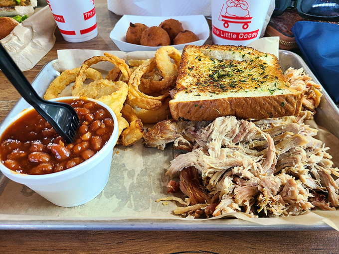 This isn't just a meal, it's edible architecture &ndash; pulled pork, baked beans, garlic toast, and onion rings building a monument to Southern comfort.