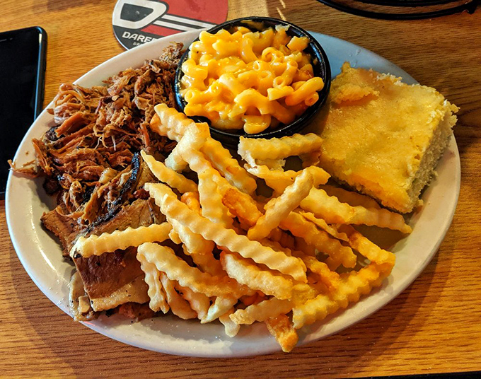 A plate that doesn't need fancy garnishes &ndash; just pulled pork, mac and cheese, fries, and cornbread forming the Mount Rushmore of barbecue satisfaction.