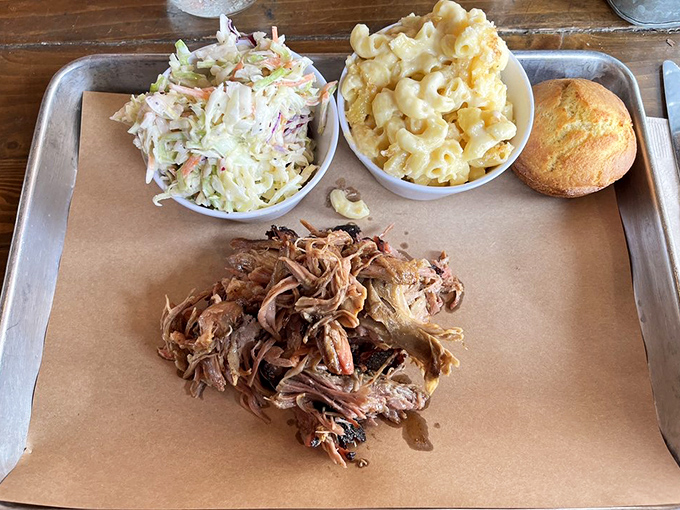Pulled pork that's had a proper introduction to smoke before being gently coaxed apart, served with creamy slaw and golden cornbread.
