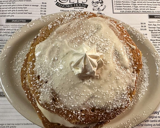 This isn't just a pancake&mdash;it's a golden cloud dusted with powdered sugar and topped with a dollop of heaven. Breakfast or dessert? Yes.
