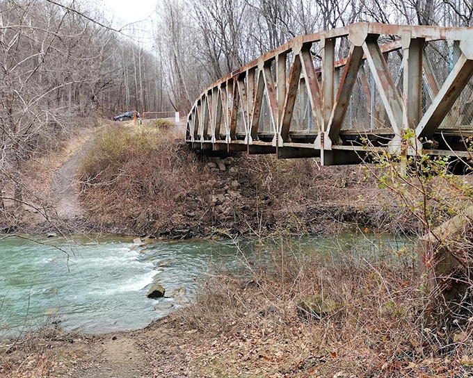 This modern bridge along the trail system stands where trains once thundered, connecting hikers to history with every crossing.