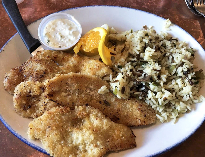 Golden razor clams nestled next to rice pilaf &ndash; proof that simple done right beats complicated every time.
