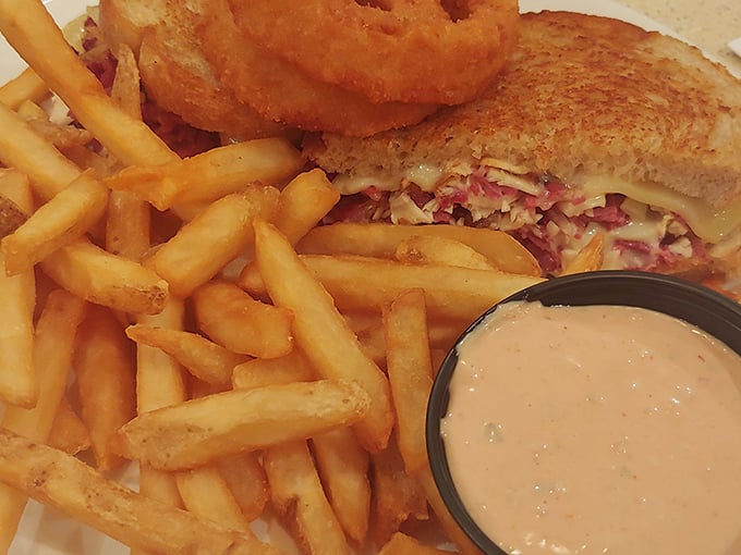 This isn't just a sandwich&mdash;it's architecture on a plate. Crispy, gooey, savory perfection with fries that deserve their own fan club.