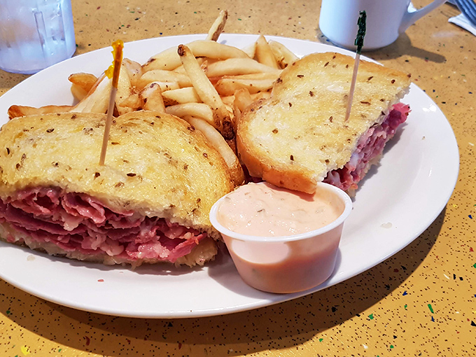 A proper Reuben should require strategic planning to eat. This mountain of pastrami demands both napkins and commitment.