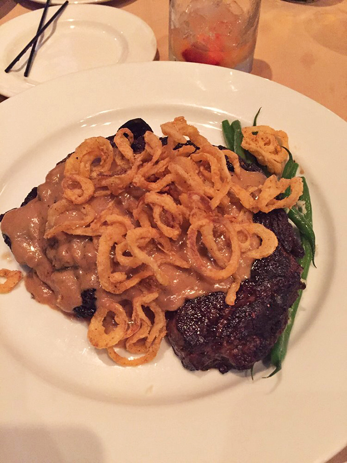 A ribeye topped with crispy onions that could make a vegetarian question their life choices. The sauce alone deserves its own fan club.