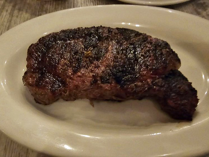 This ribeye arrives with the confidence of Sinatra walking onto stage—it knows it's about to blow your mind.