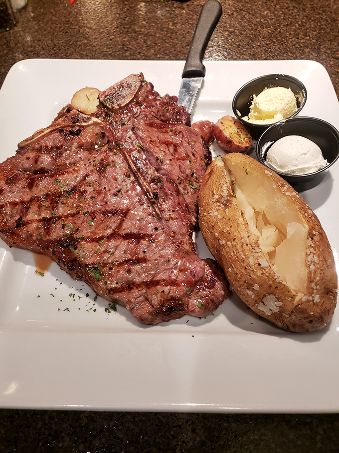 This isn't just a steak; it's a carnivore's dream canvas, painted with perfect grill marks and accompanied by a potato that's practically begging to be devoured.