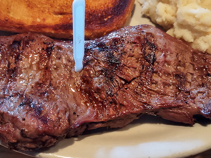 The blue temperature marker stands like a tiny flag claiming territory on a beautifully seared ribeye. This isn't just meat&mdash;it's a statement of purpose.