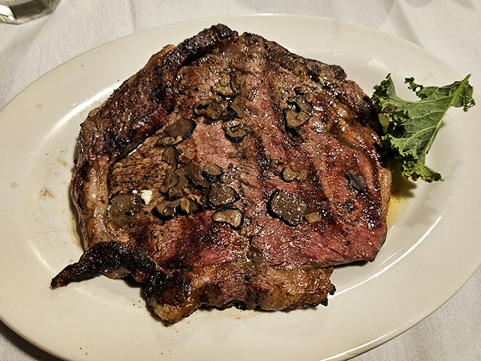The ribeye arrives like a masterpiece on a canvas of white porcelain&mdash;a beautiful relationship between fire, seasoning, and exceptional beef.