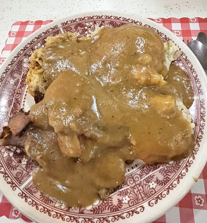 Gravy isn't just a condiment here, it's practically a beverage. This open-faced roast beef sandwich disappears faster than your New Year's resolutions.